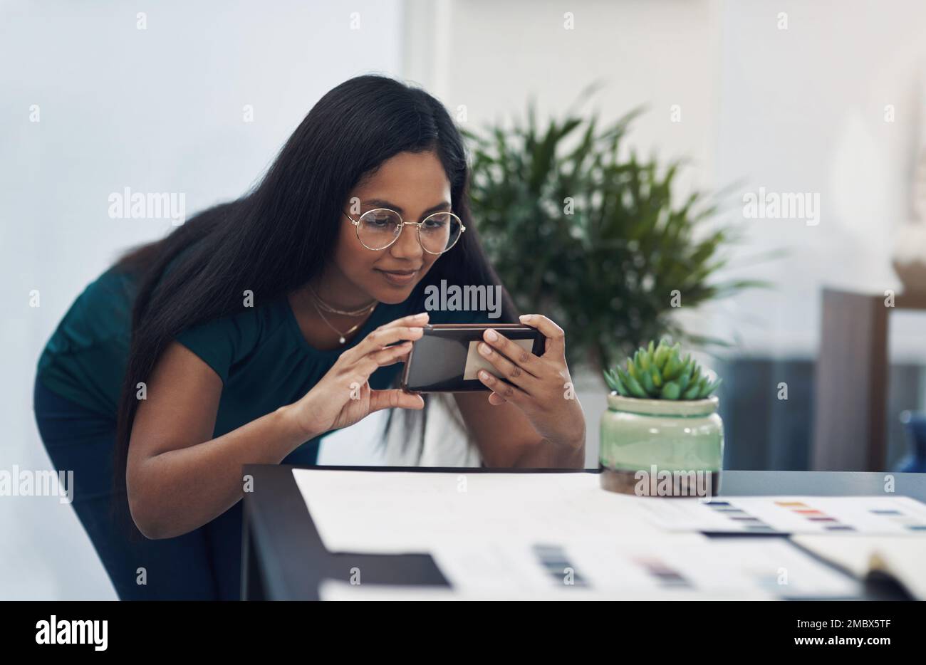 Taking pics to see the different layouts she can work with. a young ...