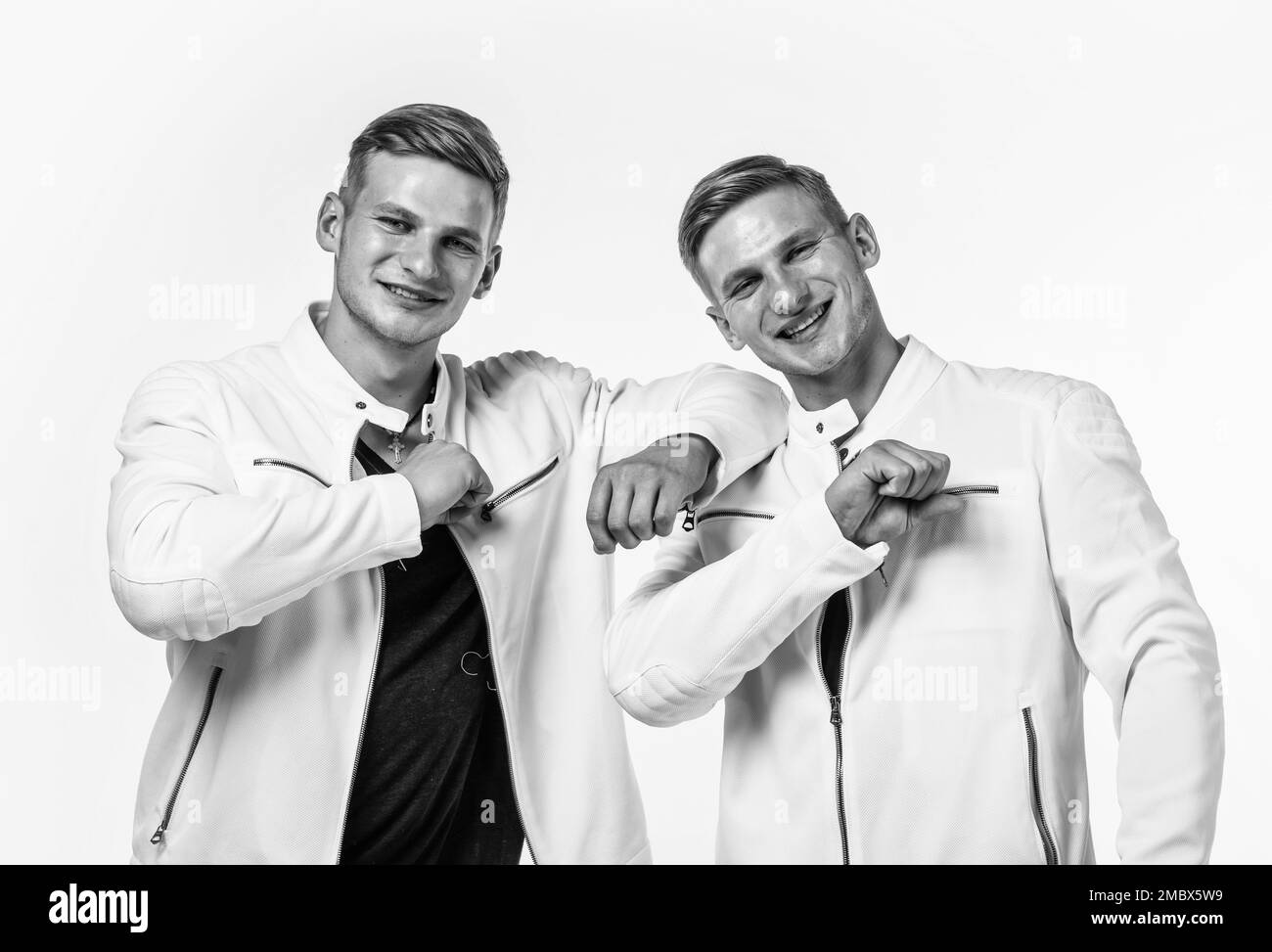 twin brothers men in white casual clothes look alike, together Stock ...