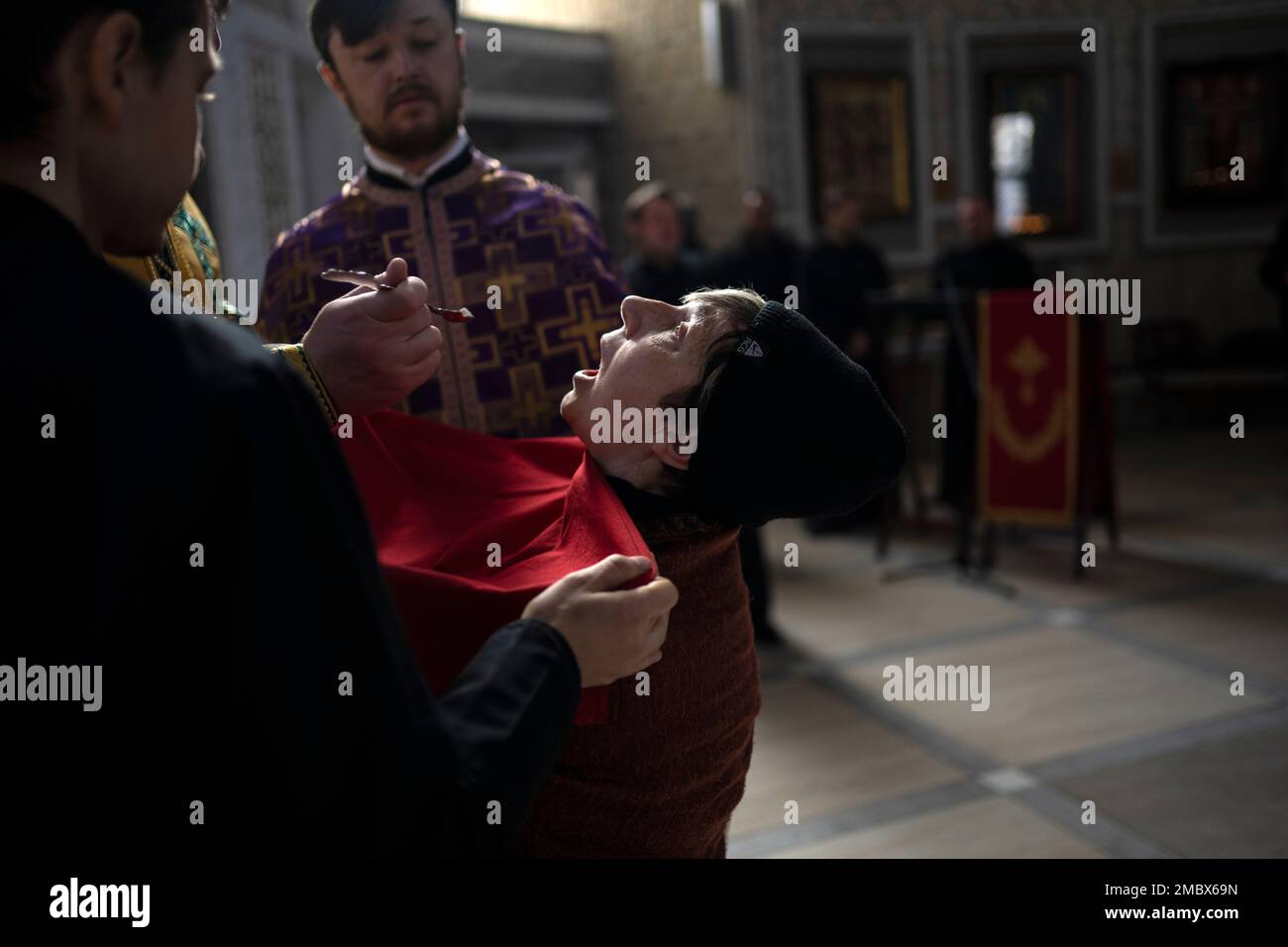 A woman receives the communion inside the "Transfiguration of Jesus ...