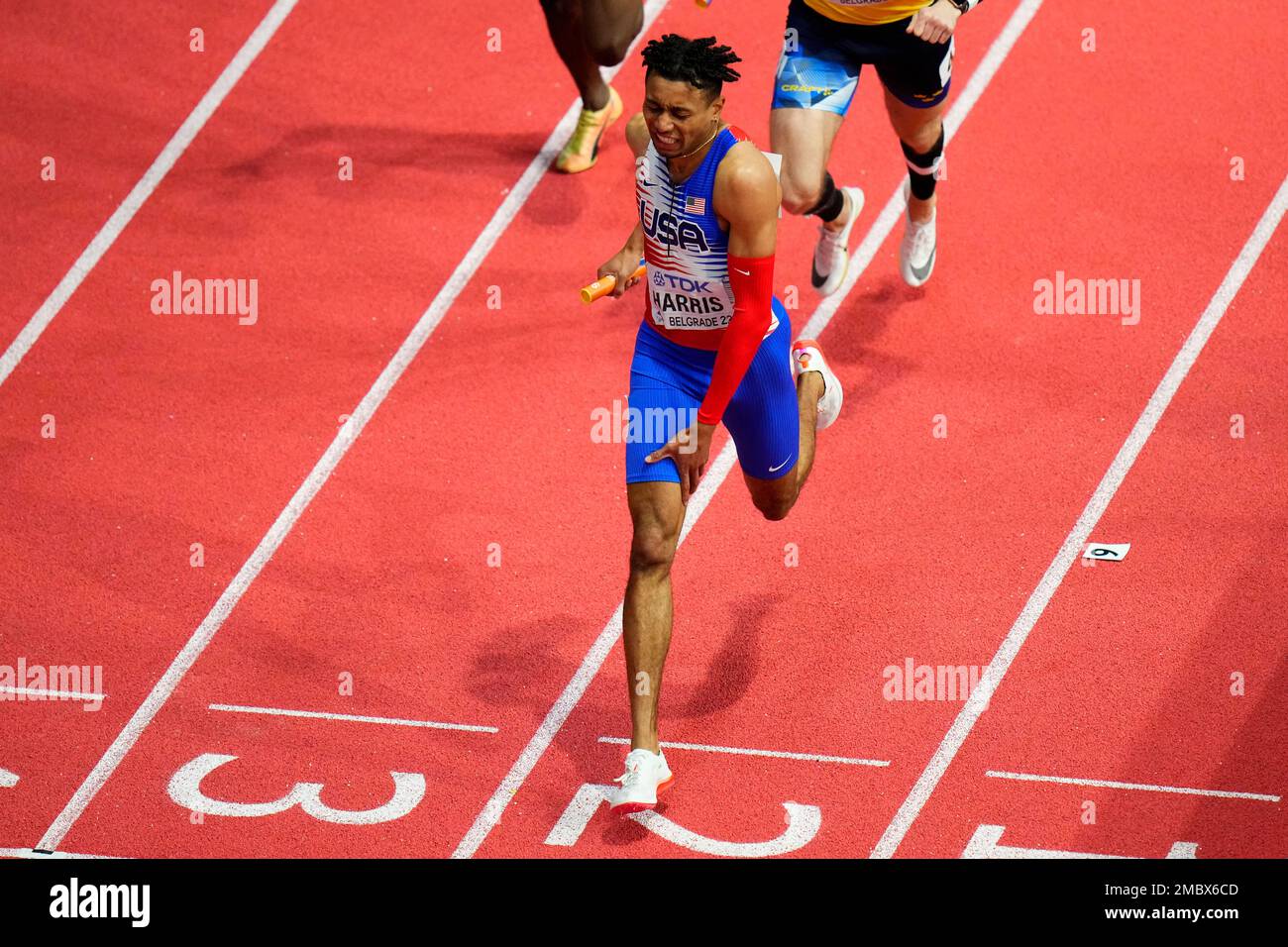 Isaiah Harris, of the United States, grimaces as he crosses the finish ...