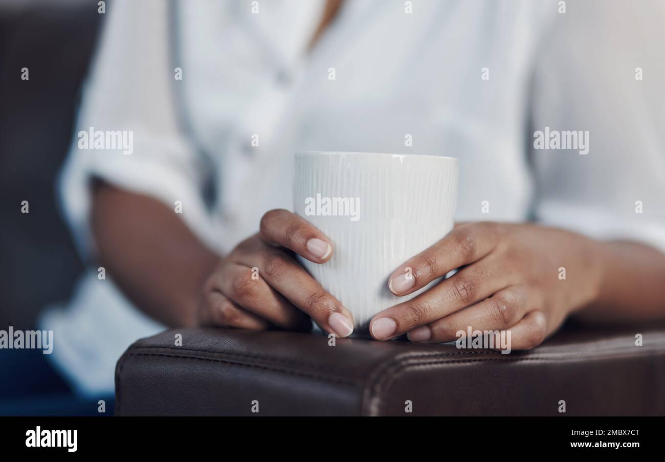 Chilling in the office lounge with some caffeine. Closeup shot of an ...