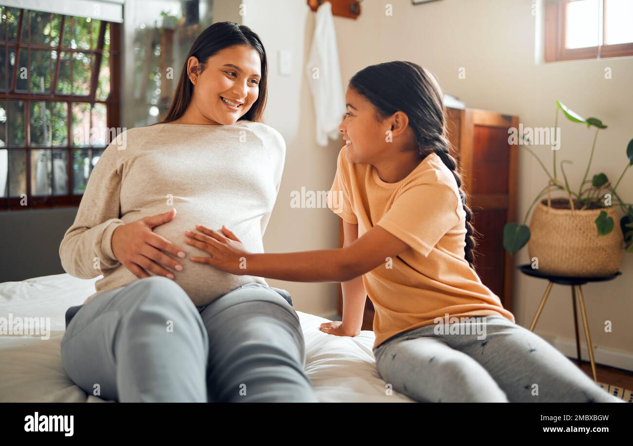 Happy, pregnant and mother with kid on bed for belly touch with excited ...