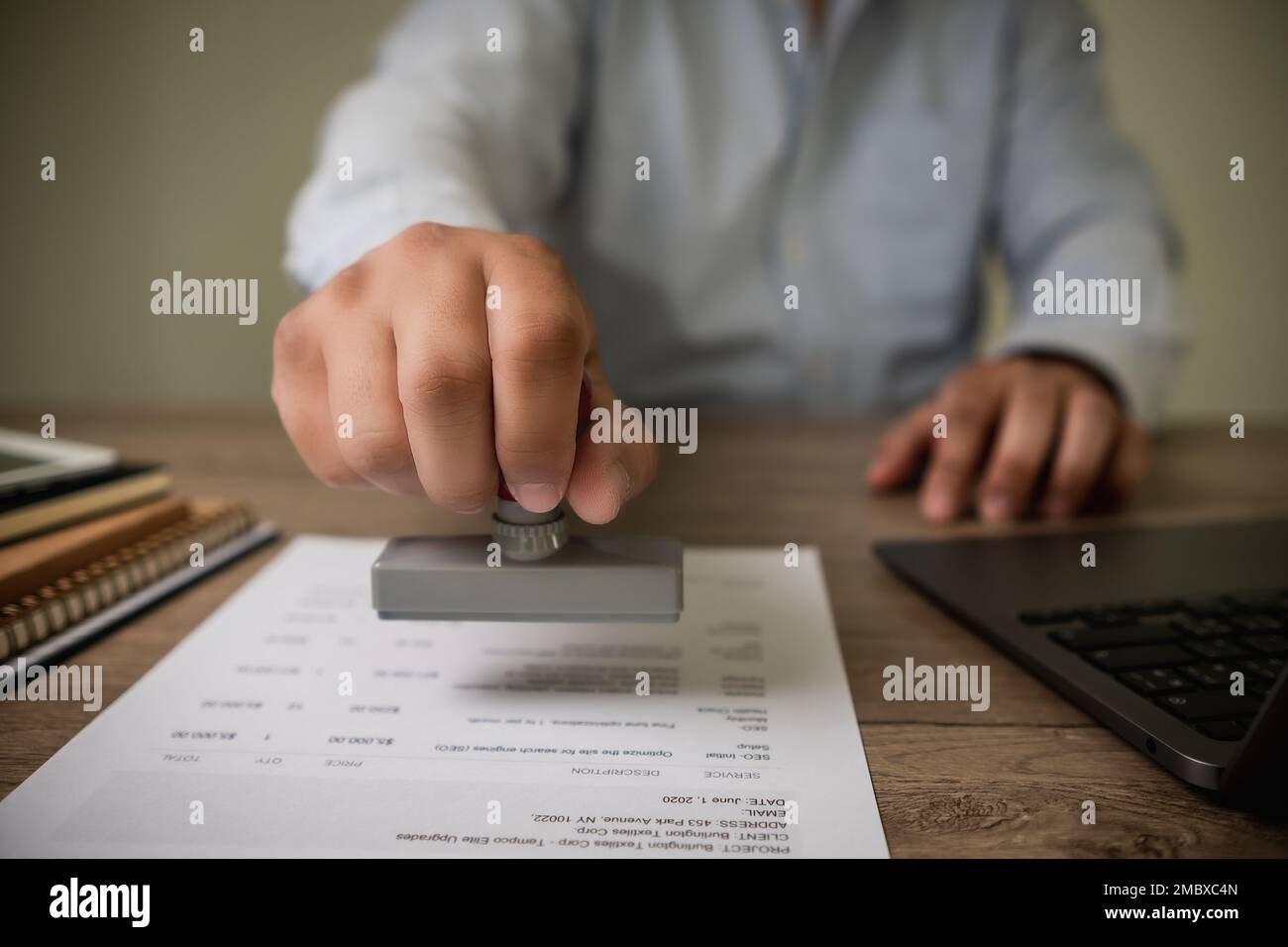 man stamping approval Text is approved by stamping the document on ...