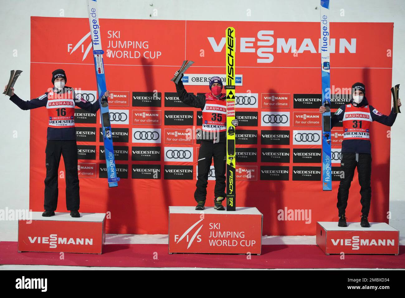 Austria's Stefan Kraft, center, celebrates his victory with second ...