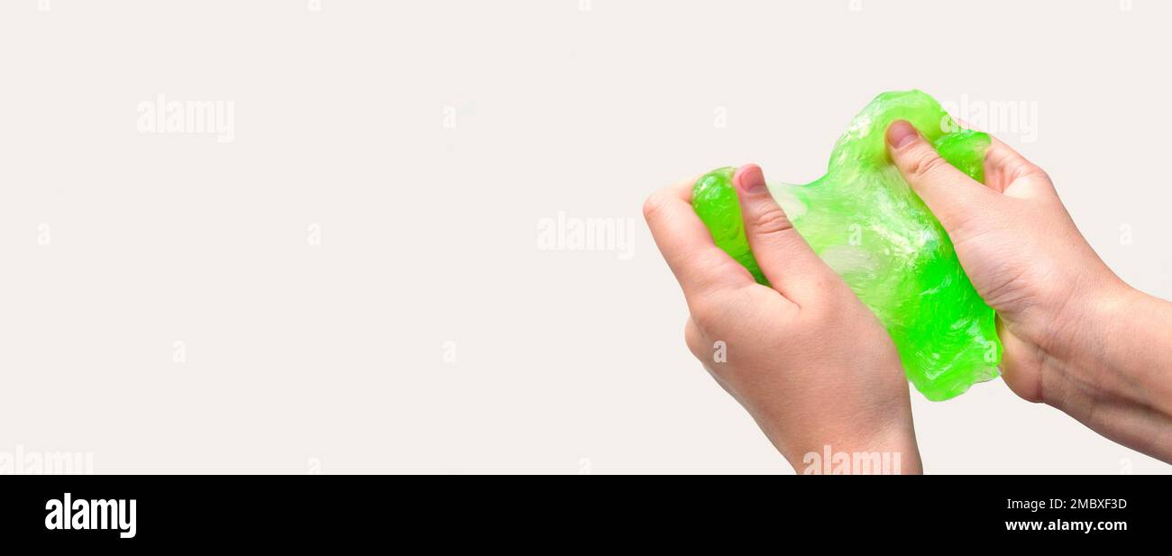 Hand Playing with textured slime on white background. Teen hand holding ...