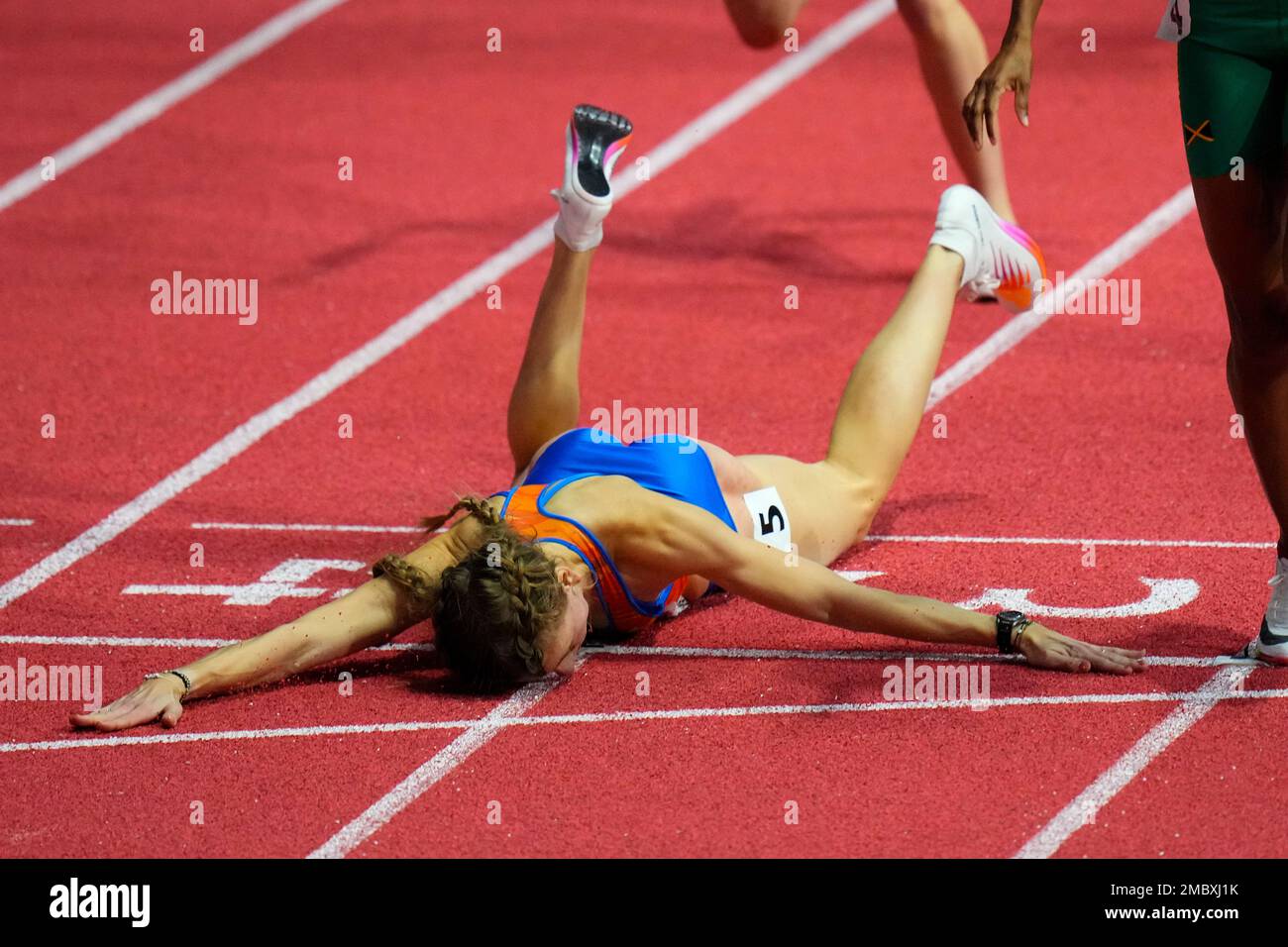 Femke Bol, of the Netherlands, falls down and hits her head on the ...