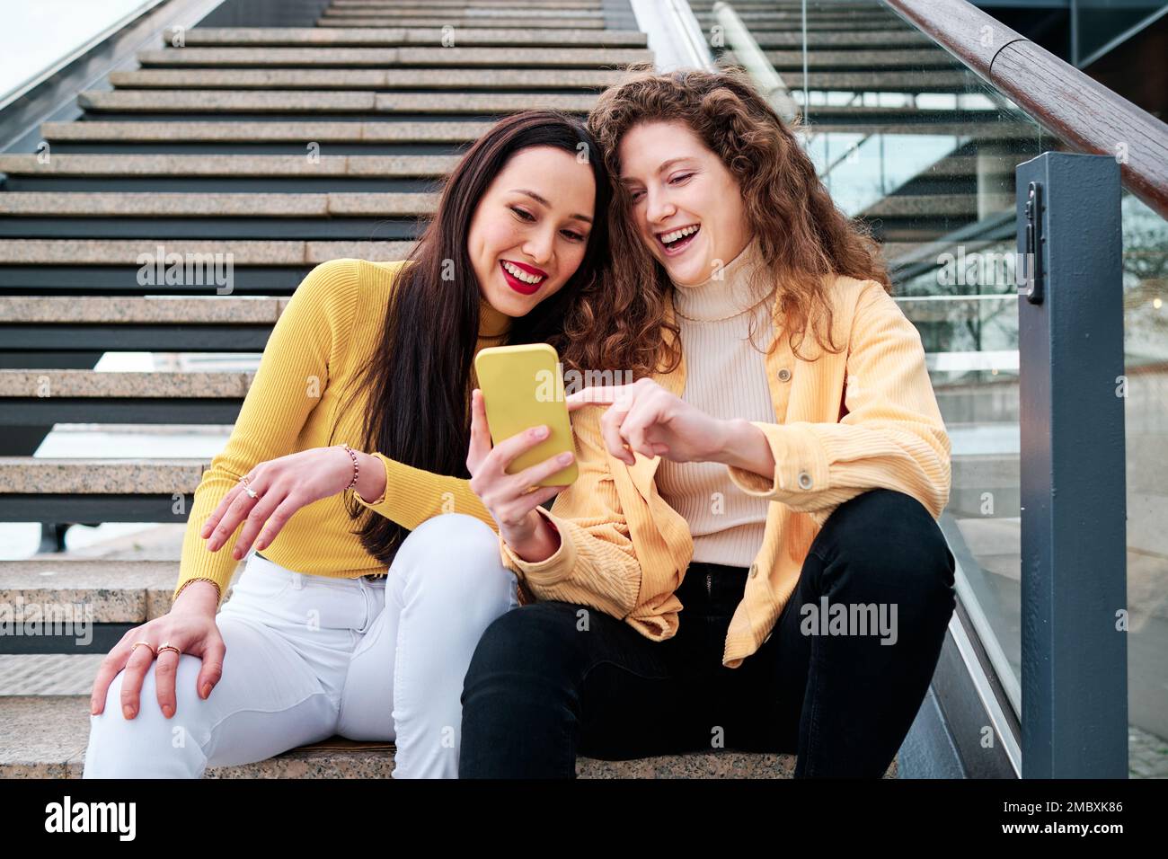 Two people sitting on stairs hi-res stock photography and images - Alamy