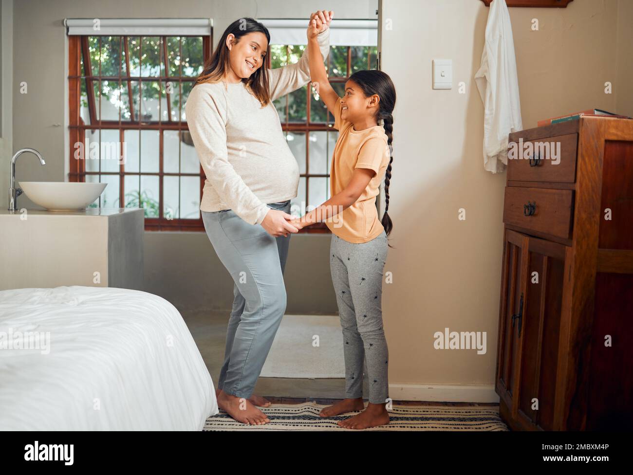Child, pregnant woman, and happy family dancing in home bedroom for ...