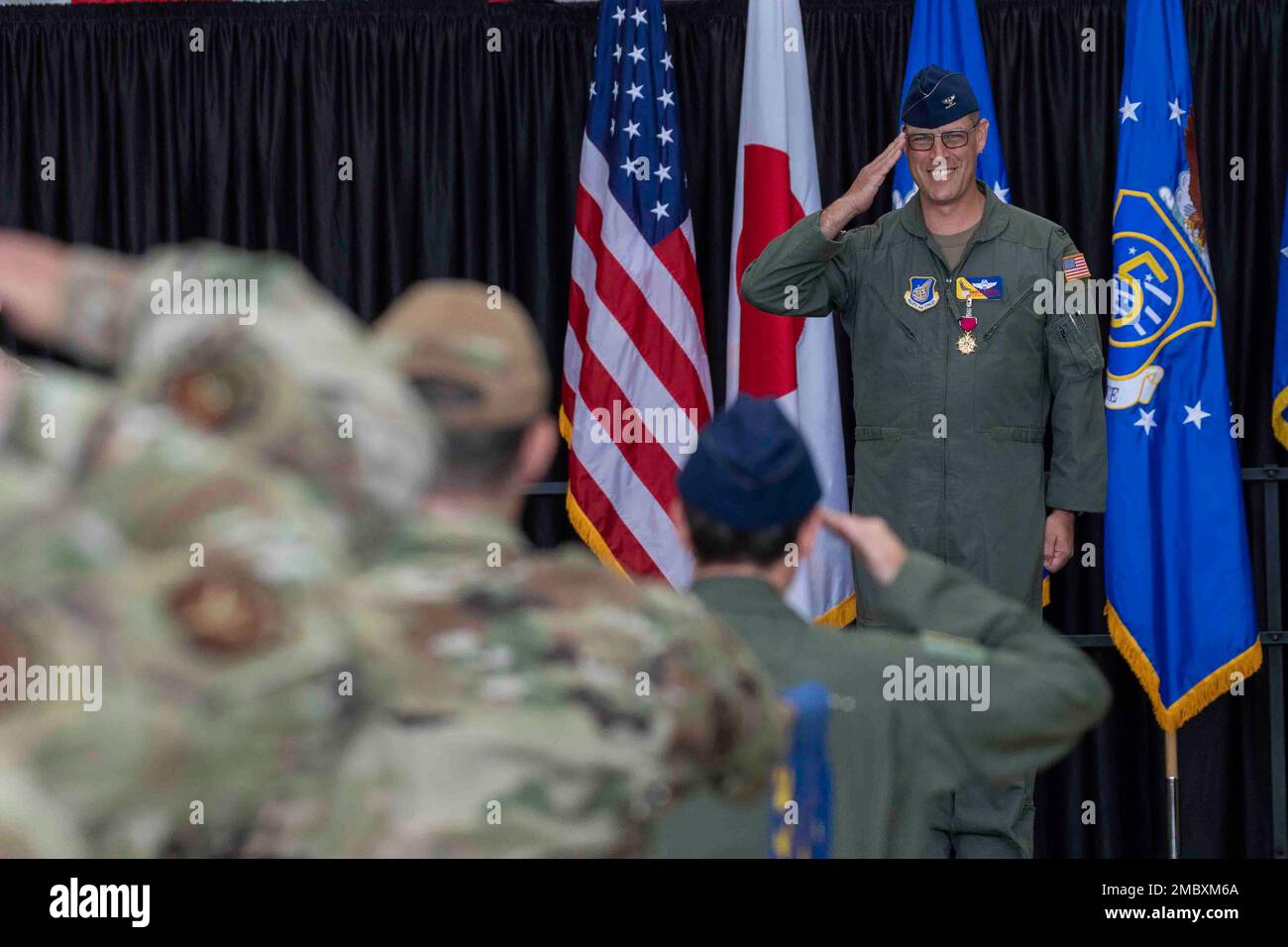 Col. Andrew Campbell, 374th Airlift Wing outgoing commander, renders his final salute as ...