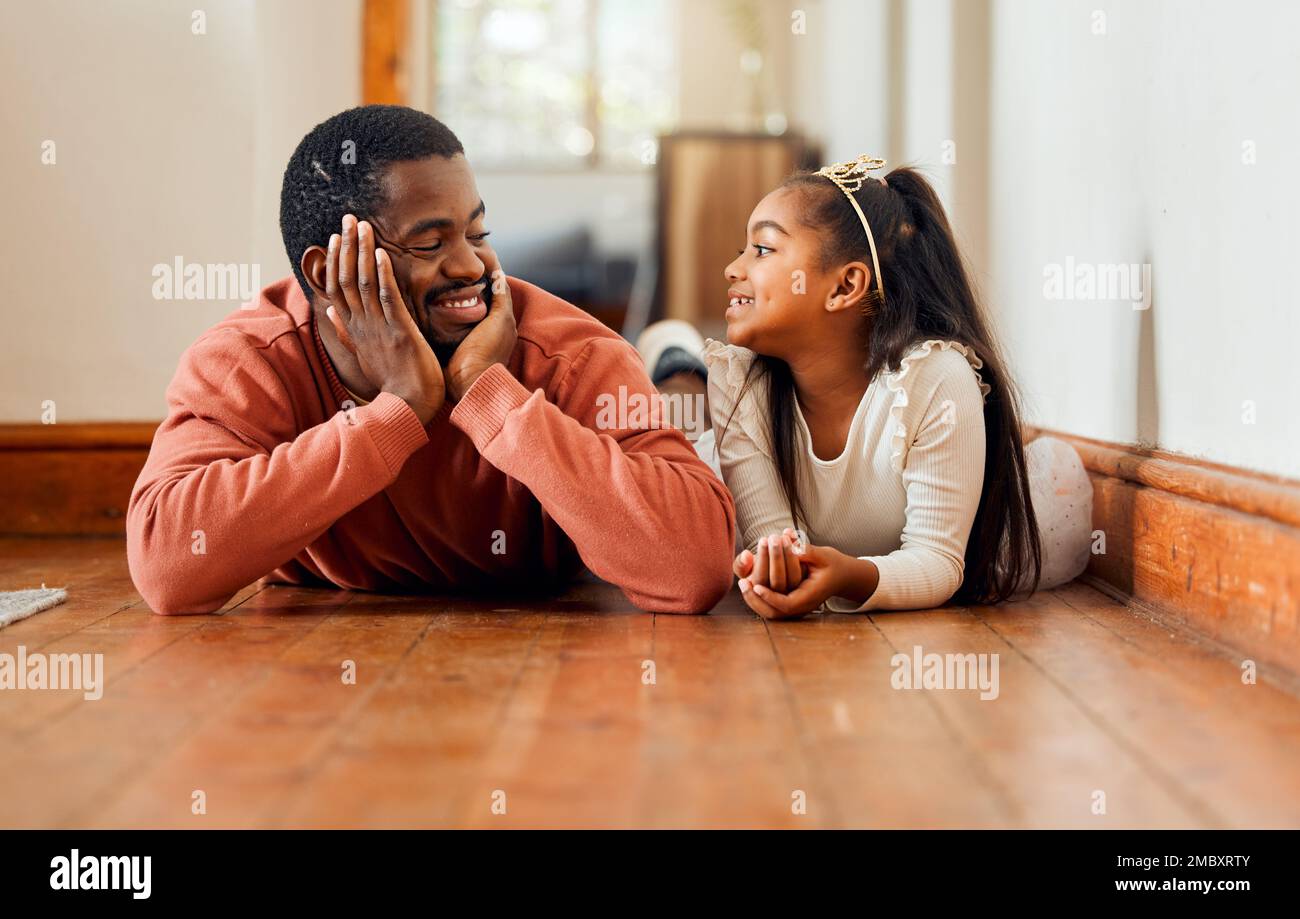Father, love and daughter relax on the floor, happy and bonding while ...
