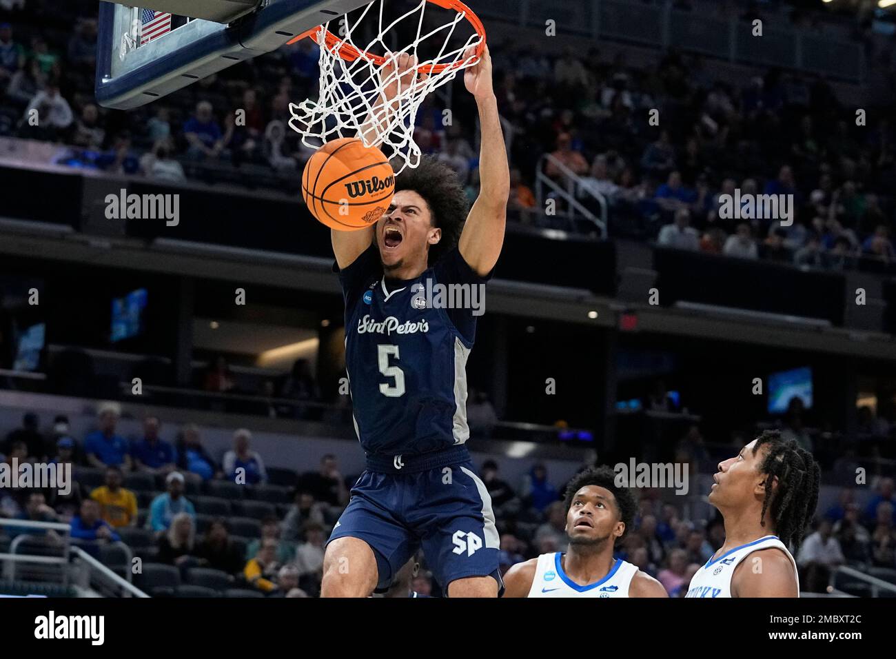 St. Peter's guard Daryl Banks III (5) dunks the gall during the first ...