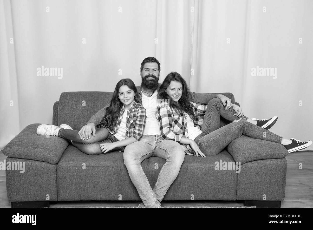 happy family portrait sitting on sofa at home, family Stock Photo - Alamy