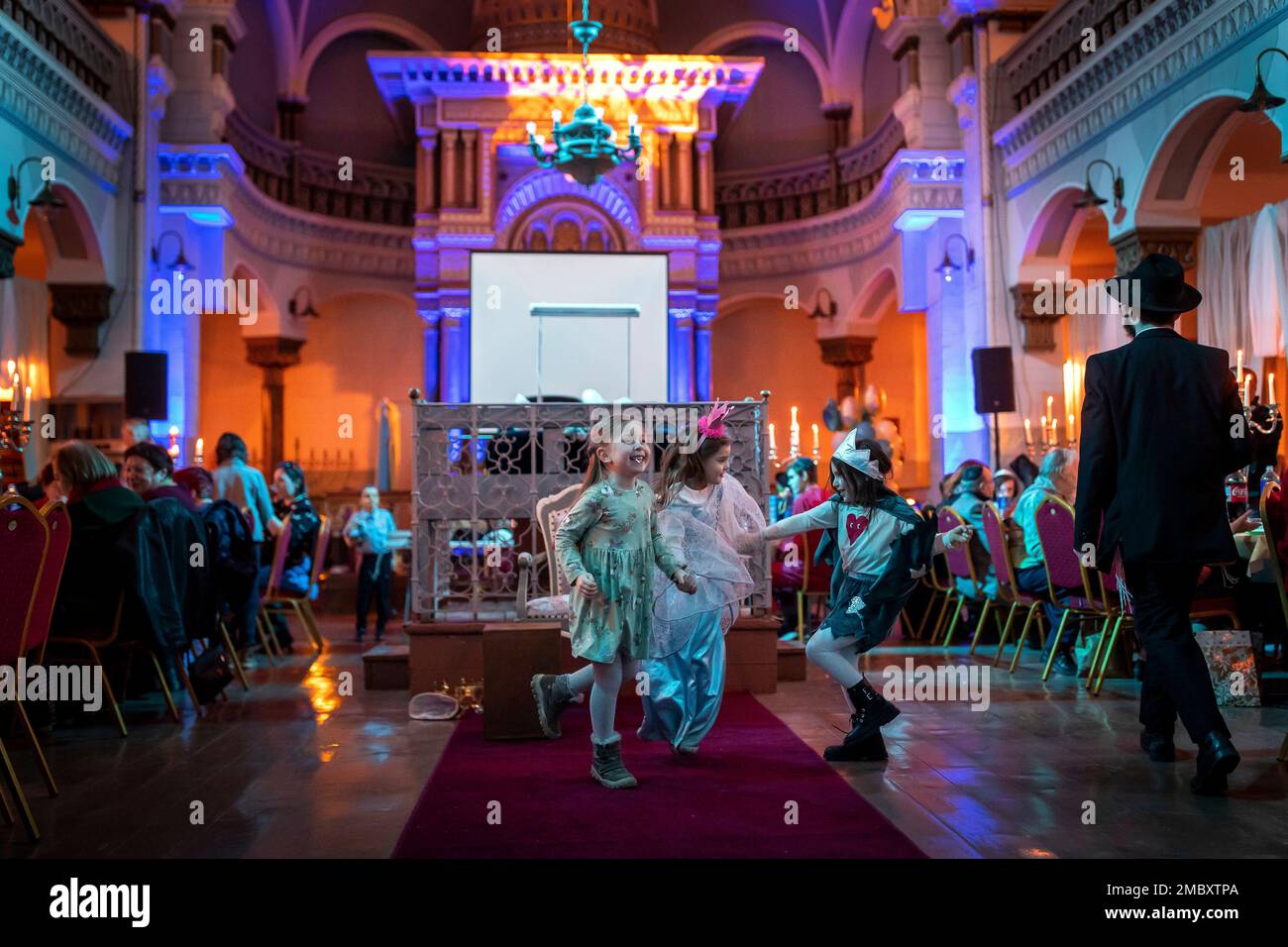 Girls dance during the Jewish festival of Purim at a synagogue in ...