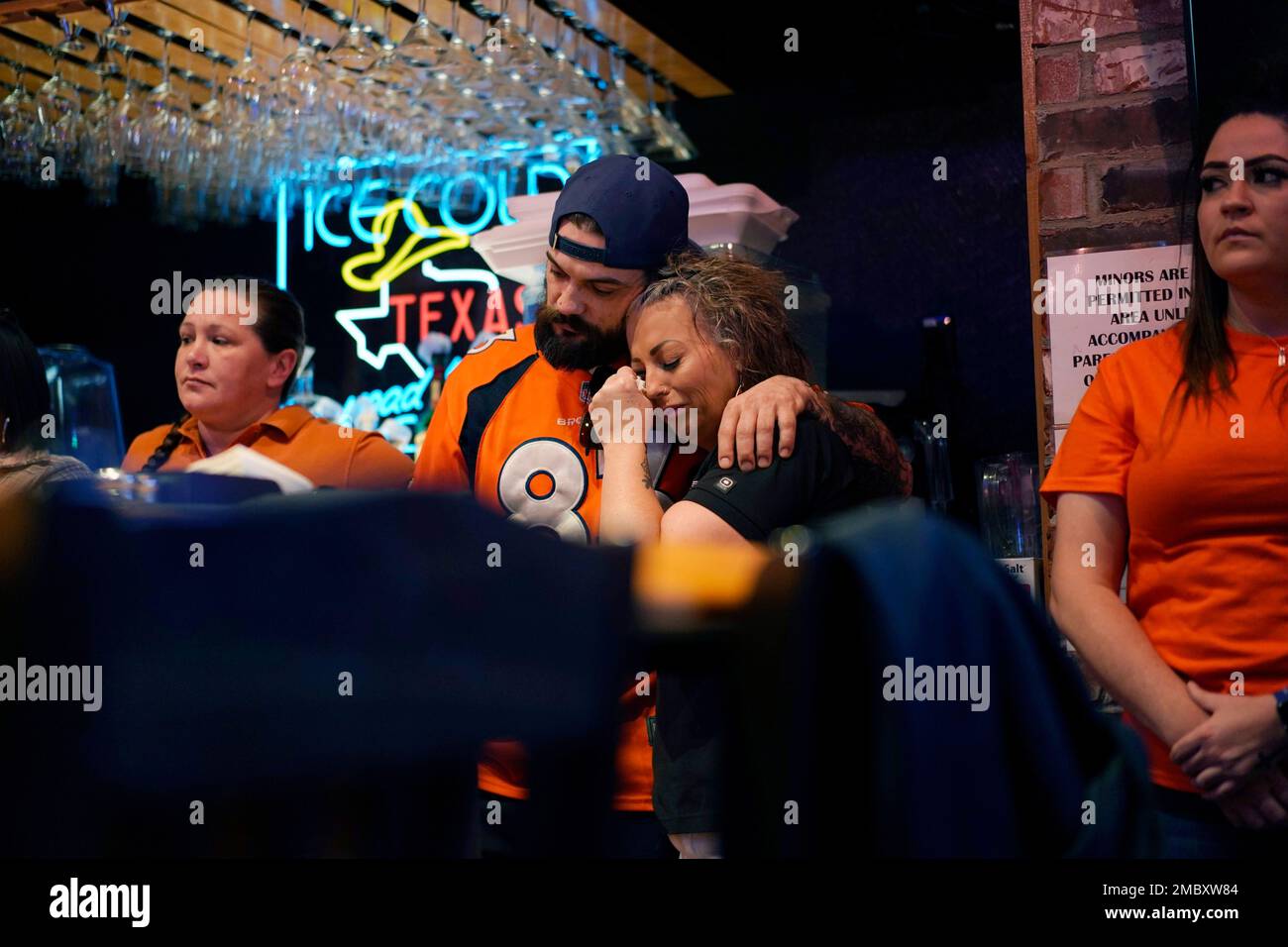 Erik Herring, center left, and Andera Concotelli console each other ...