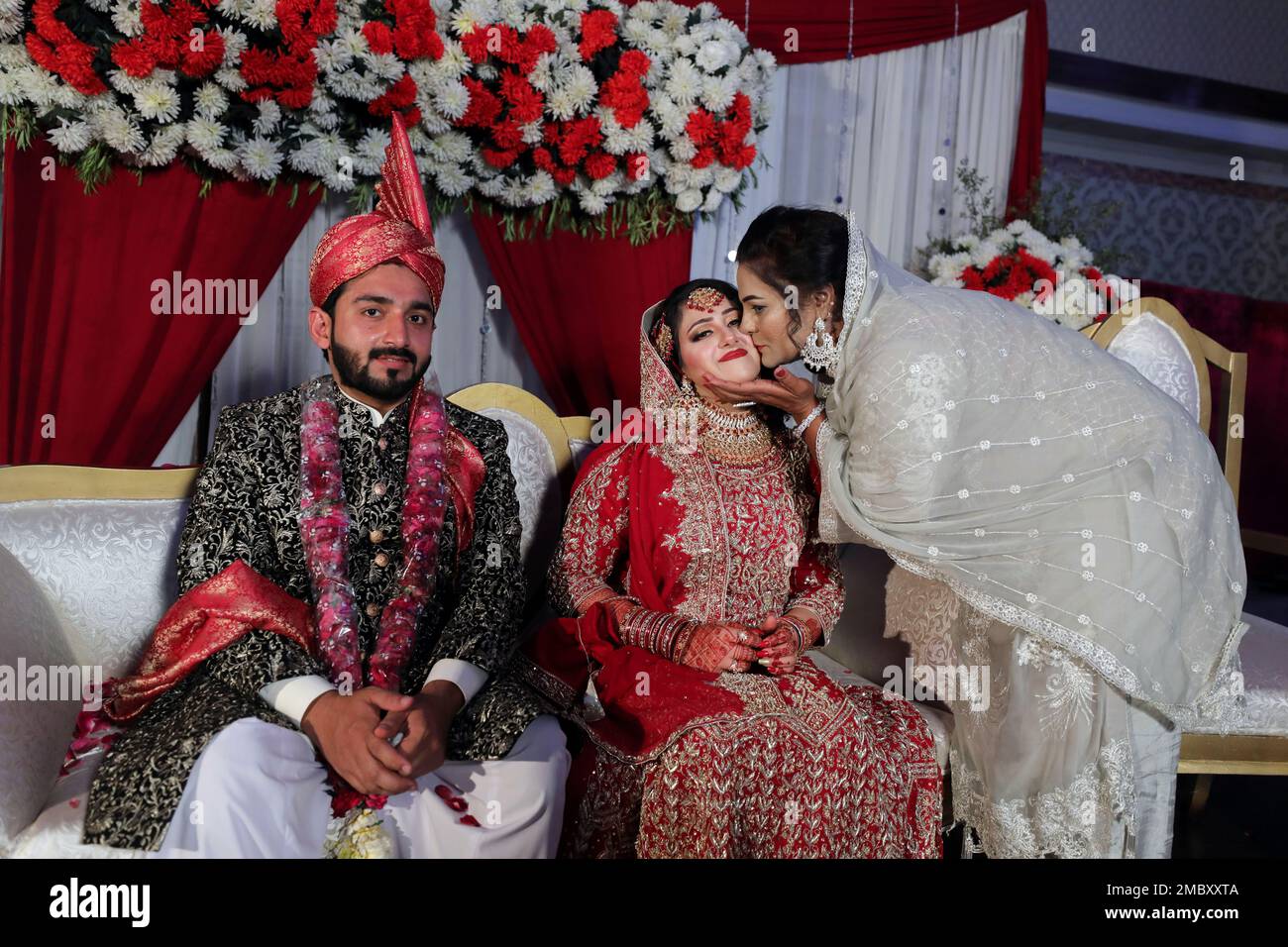 A mother of bride, right, kisses her daughter Musfira Shams, during her ...