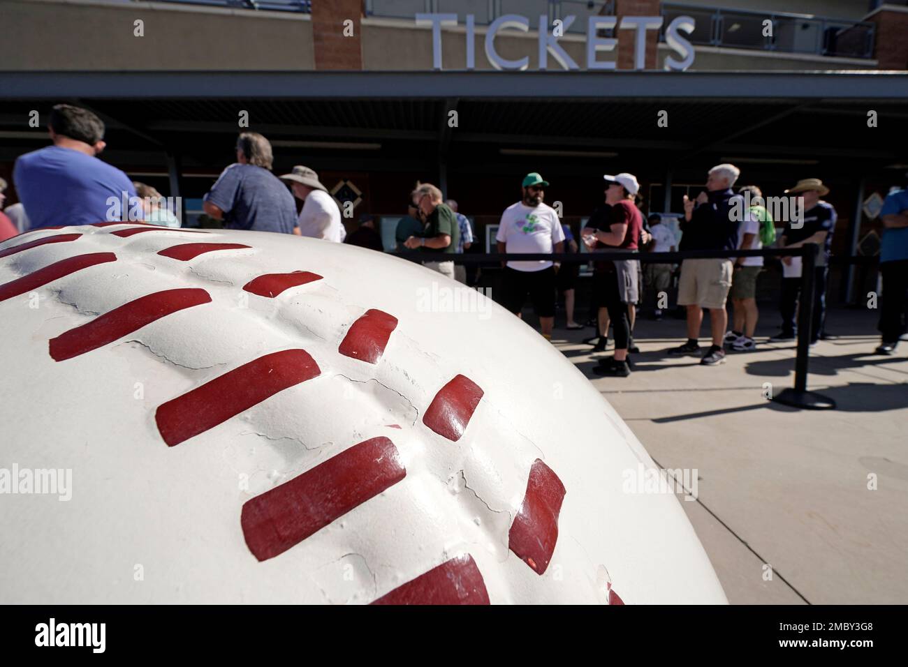 People wait in line to buy tickets for spring training baseball games ...