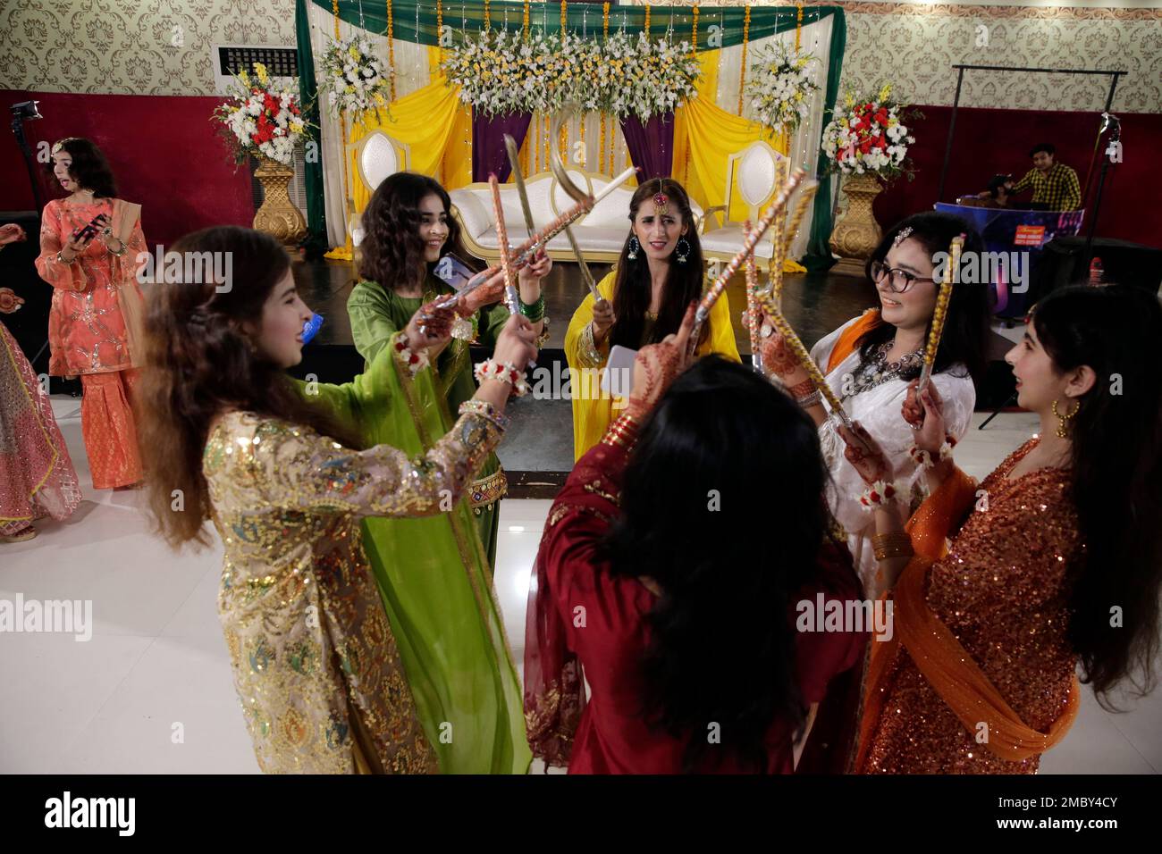 Pakistani girls participate in traditional dancing during a wedding ...
