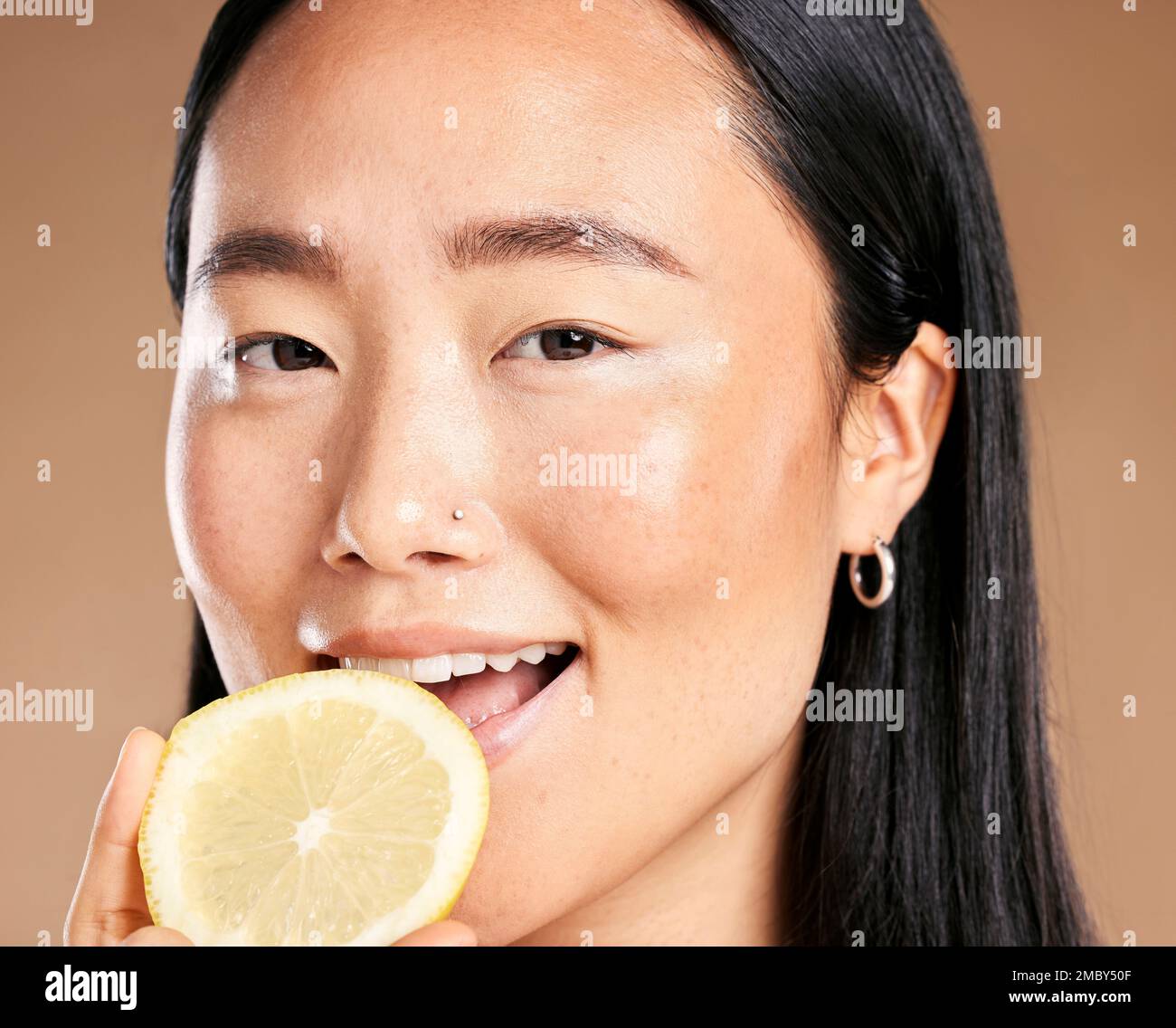 Asian woman, studio portrait and lemon for smile, healthy cosmetic glow on skin health by ...