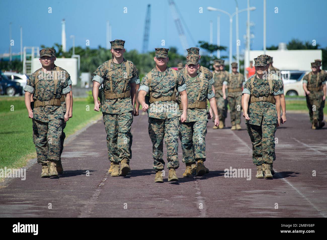 U.S. Marines and Sailors begin the pass in review during a change of ...
