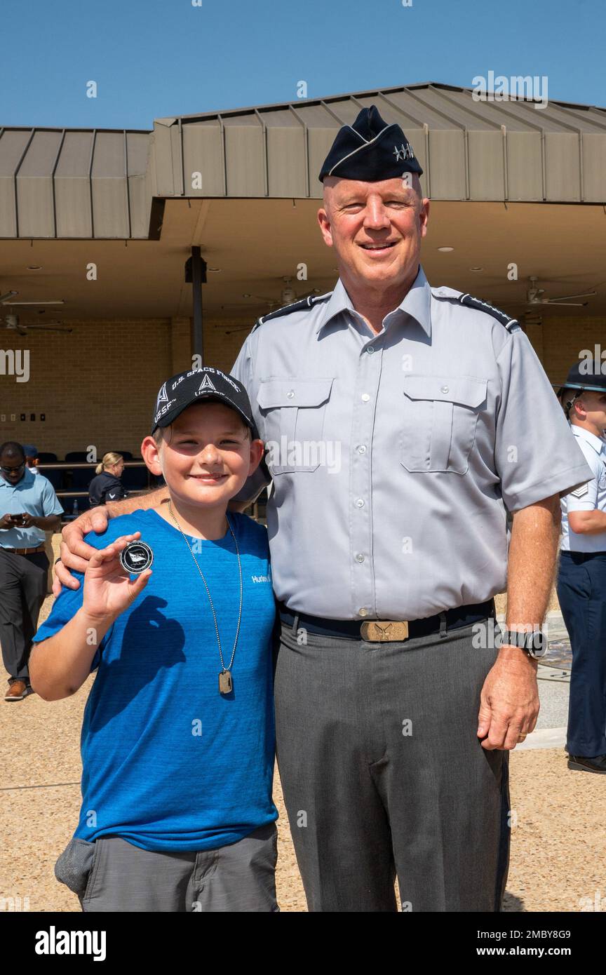 Chief of Space Operations Gen. John W. “Jay” Raymond presents a coin to ...