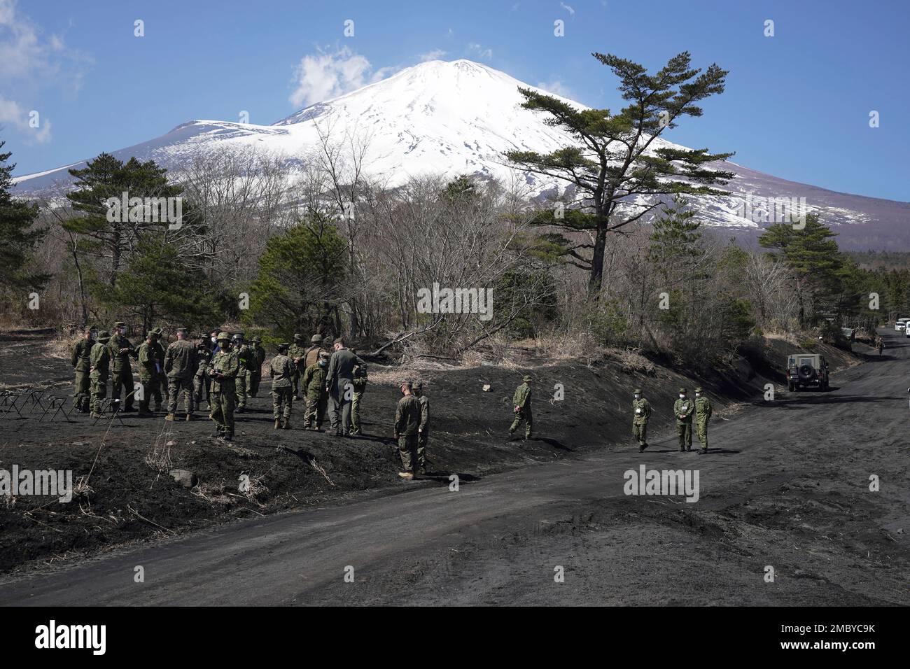 Officers gather with iconic Mount Fuji in the background during a joint ...