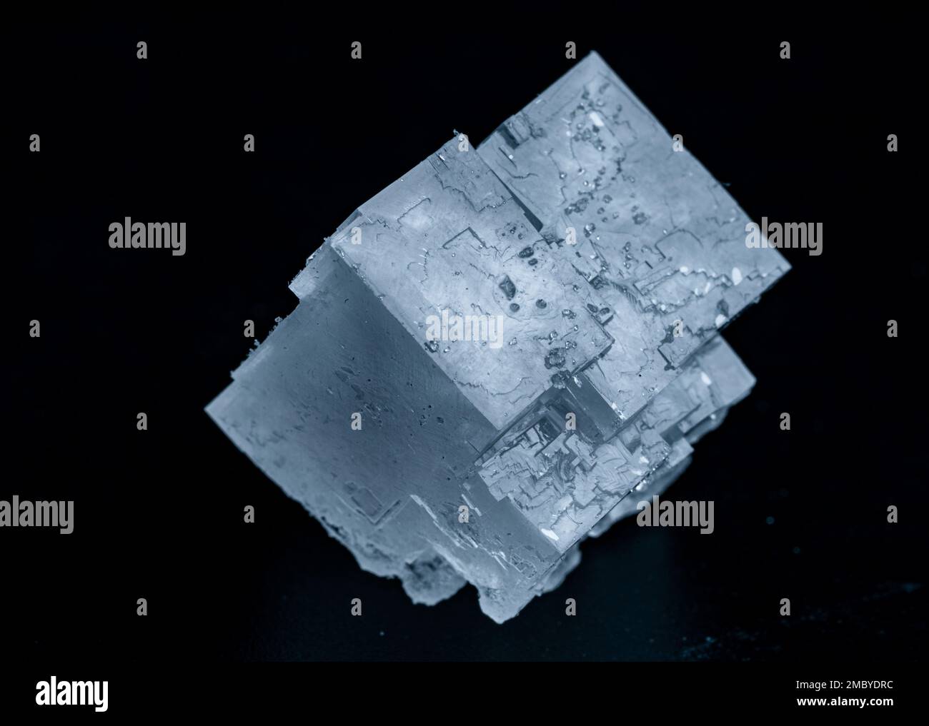 Salt crystal on a black background microscope view Stock Photo - Alamy