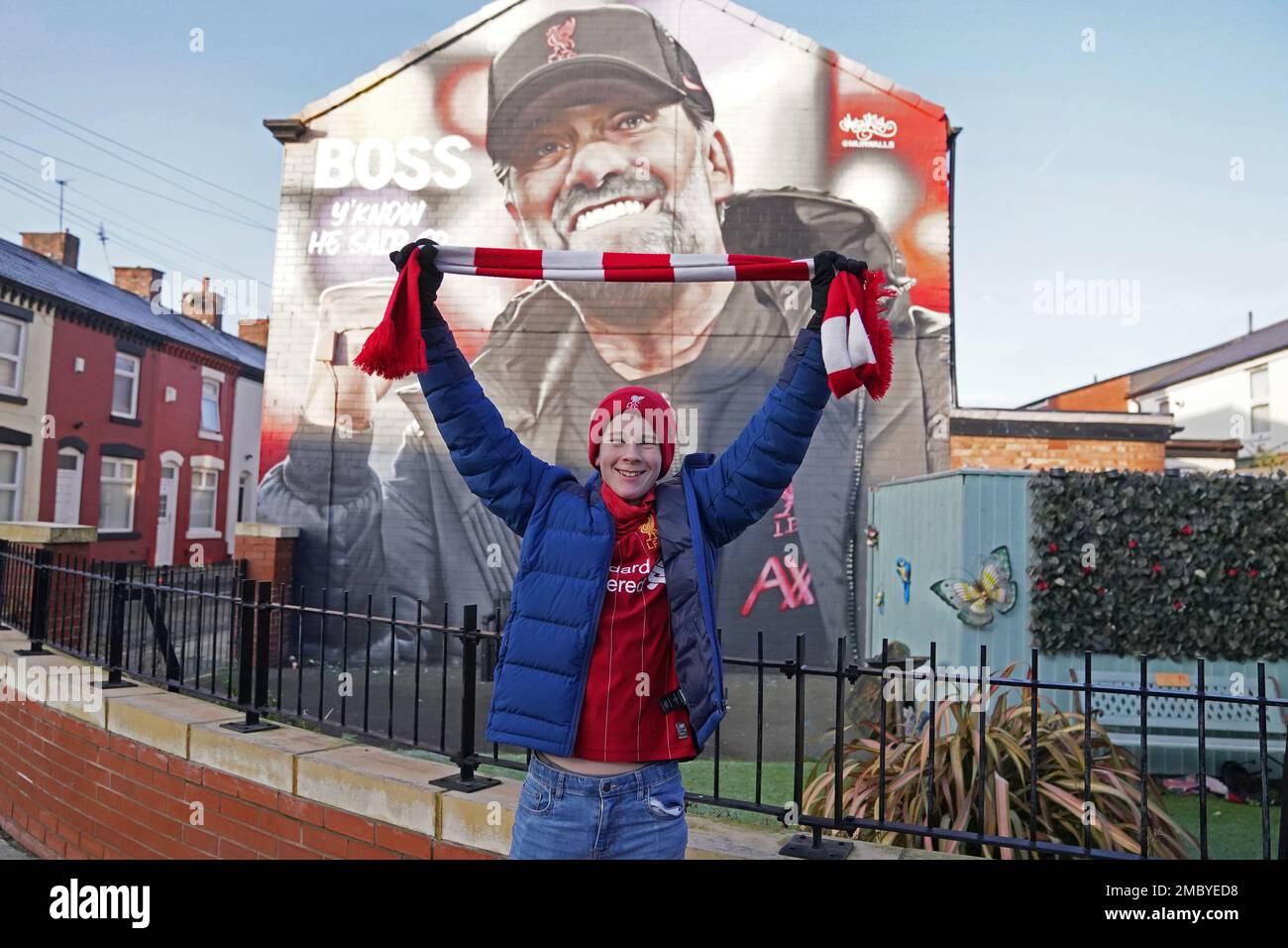A fan poses for a photo by a mural of Liverpool manager Jurgen Klopp on ...