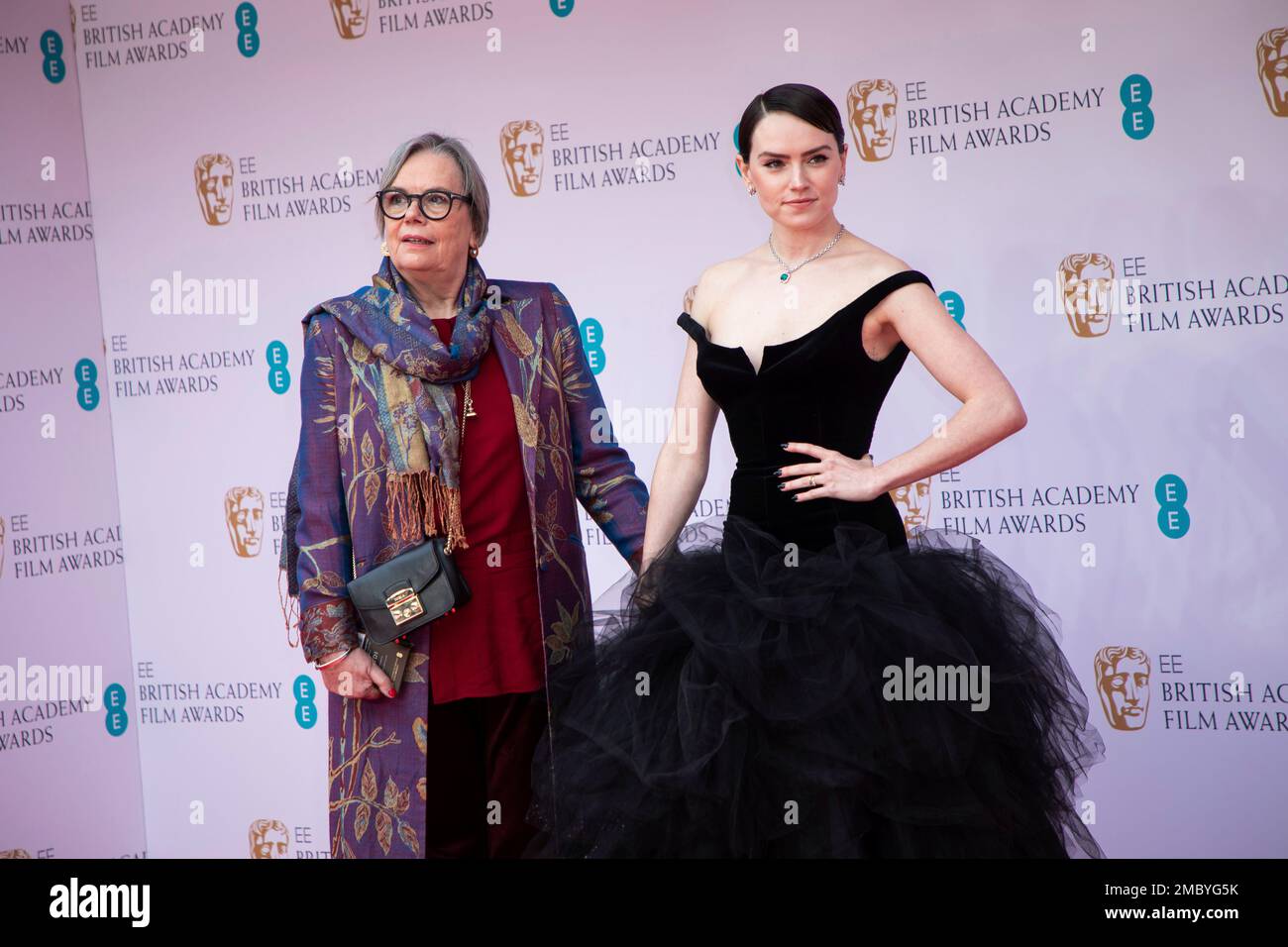 Louise Fawkner-Corbett and Daisy Ridley pose for photographers upon ...