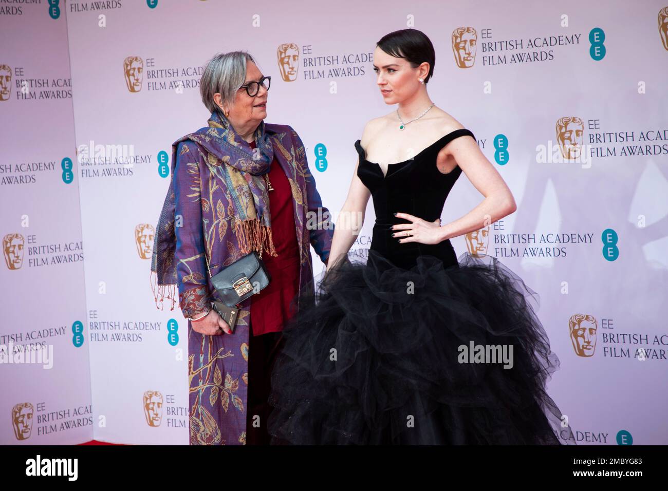 Louise Fawkner-Corbett and Daisy Ridley pose for photographers upon ...