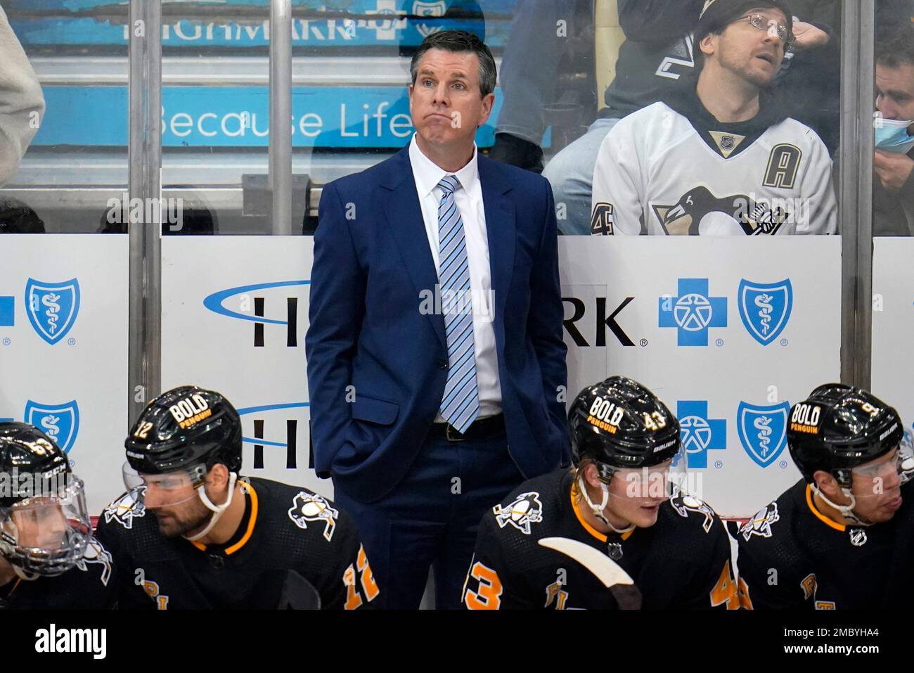 Pittsburgh Penguins head coach stands behind his bench during an NHL ...