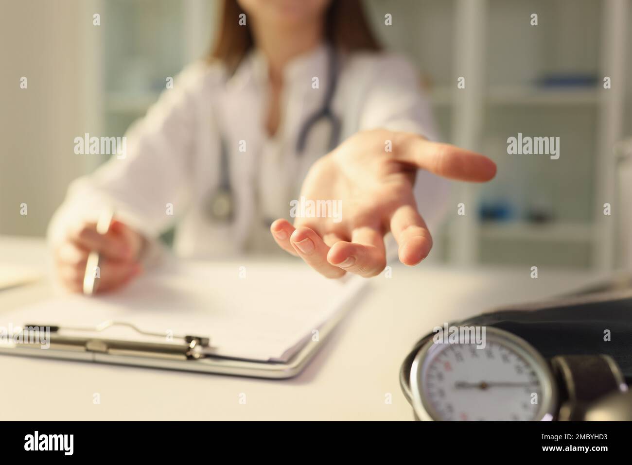 Doctor extending helping hand to patient in clinic closeup Stock Photo ...