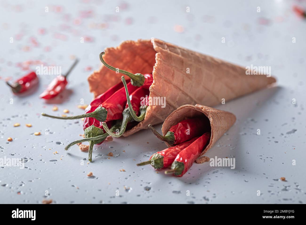 Chilli peppers in ice cream cone. Spicy ice cream concept. Unique ice ...
