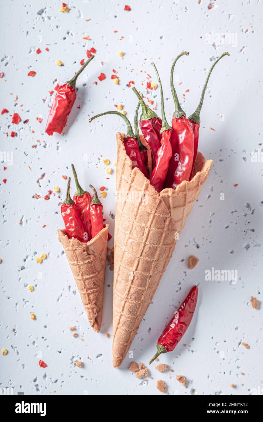 Spicy ice cream concept. Chilli peppers in ice cream cone. Unique ice ...