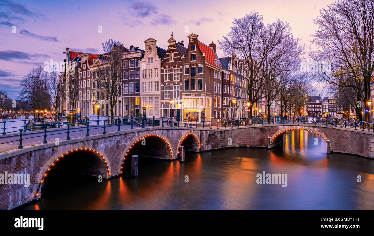 Amsterdam at night with dancing colorful houses at the Amsterdam canals ...