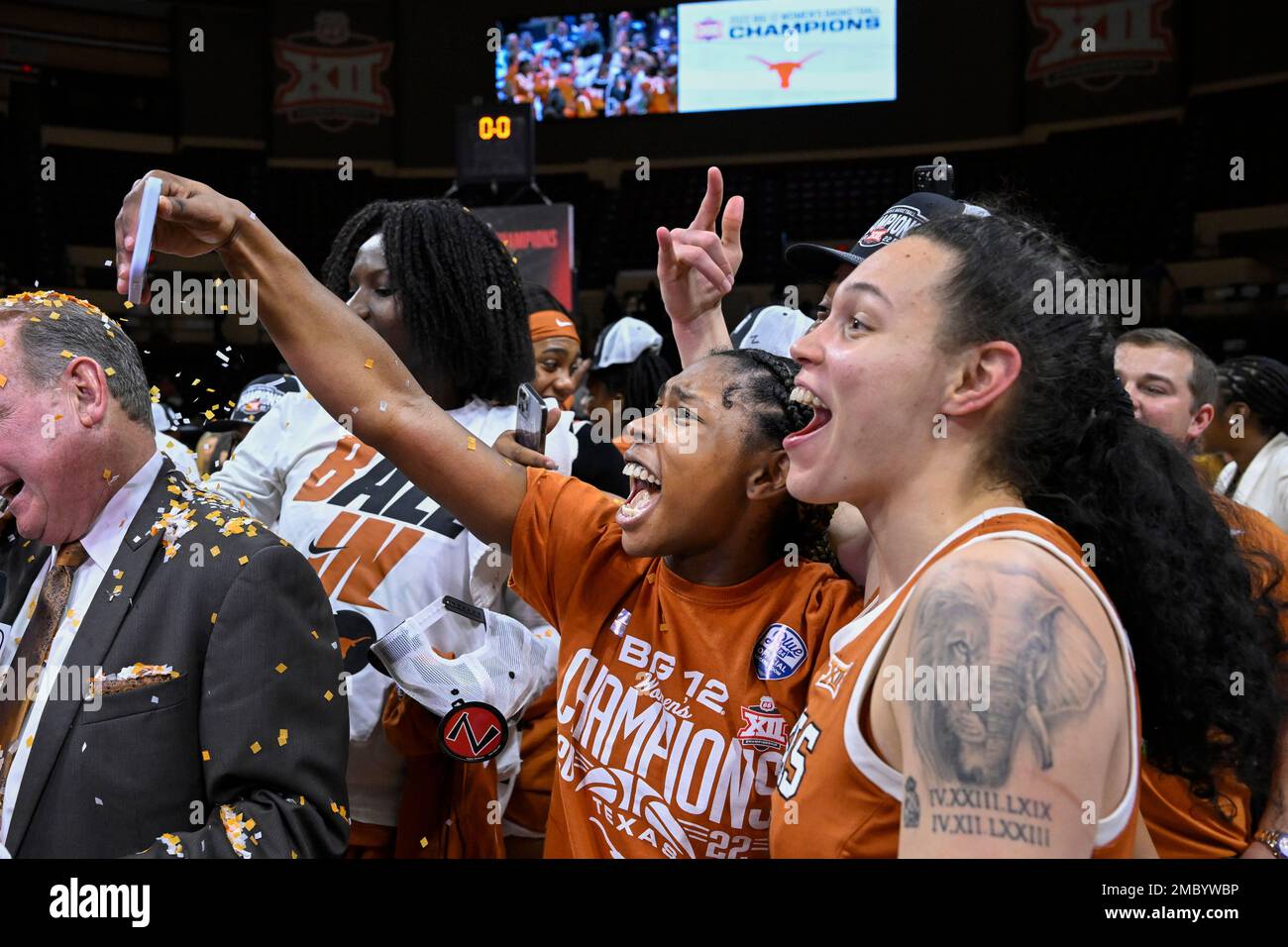 Texas guard Aliyah Matharu, holding phone, and teammate Audrey Warren ...