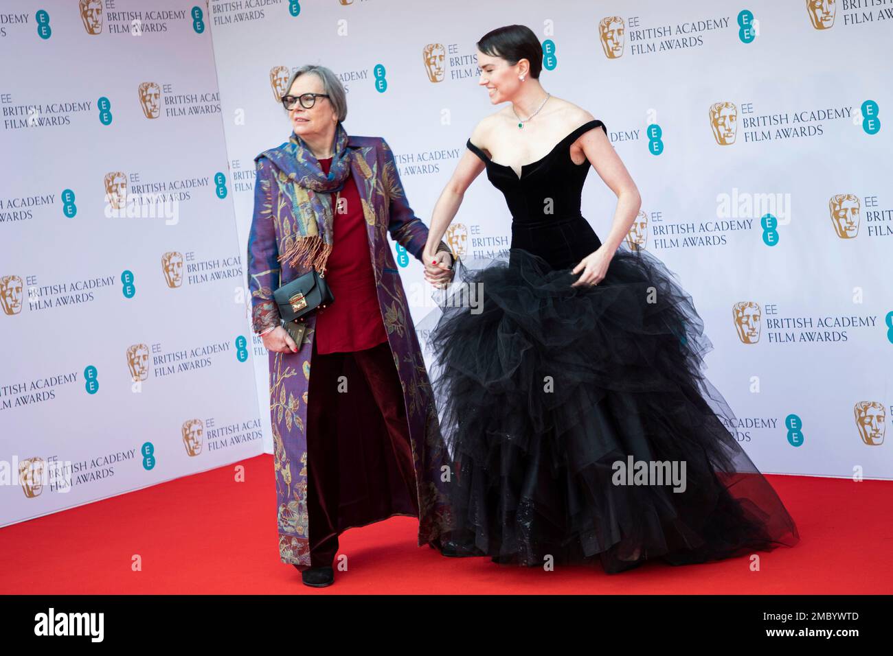 Louise Fawkner-Corbett and Daisy Ridley pose for photographers upon ...
