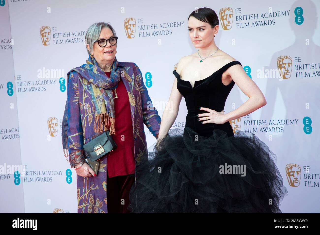 Louise Fawkner-Corbett and Daisy Ridley pose for photographers upon ...
