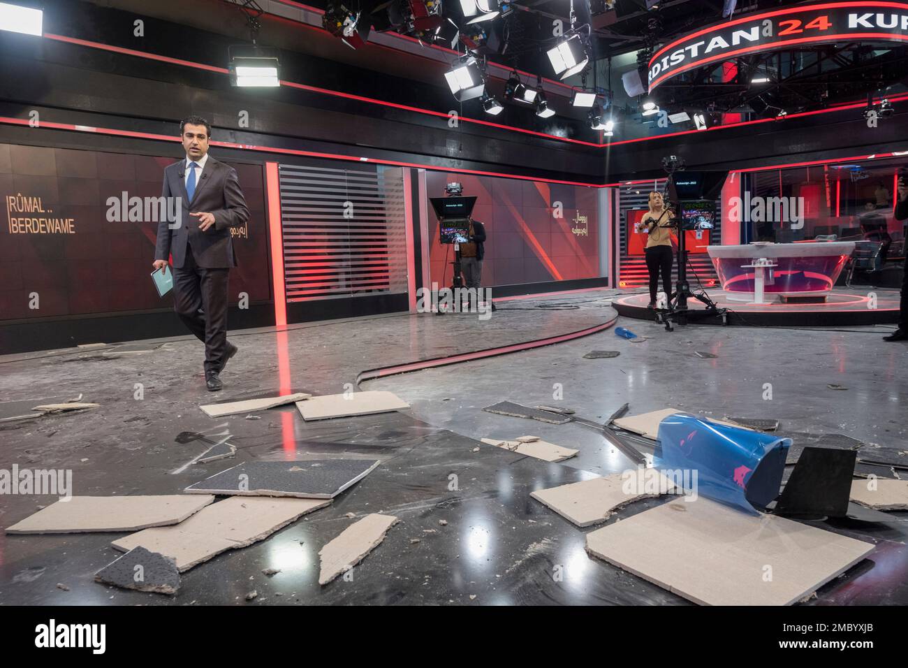Employees of Kurdistan 24, a satellite television station, work in a studio damaged by an ...