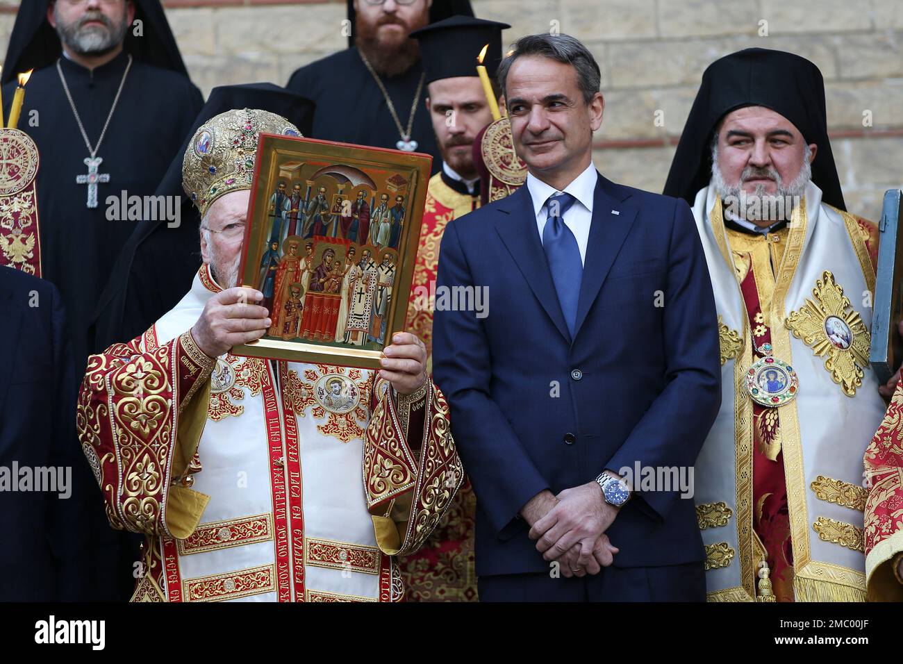 Greek Prime Minister Kyriakos Mitsotakis, center, stands next to Ecumenical Patriarch ...