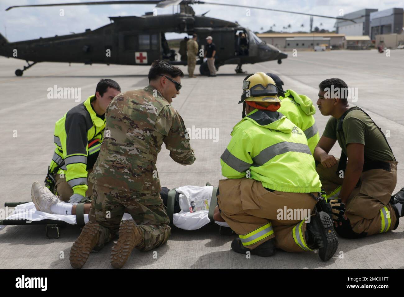 Federal Firefighters and U.S. Army soldiers prepare to load a casualty ...