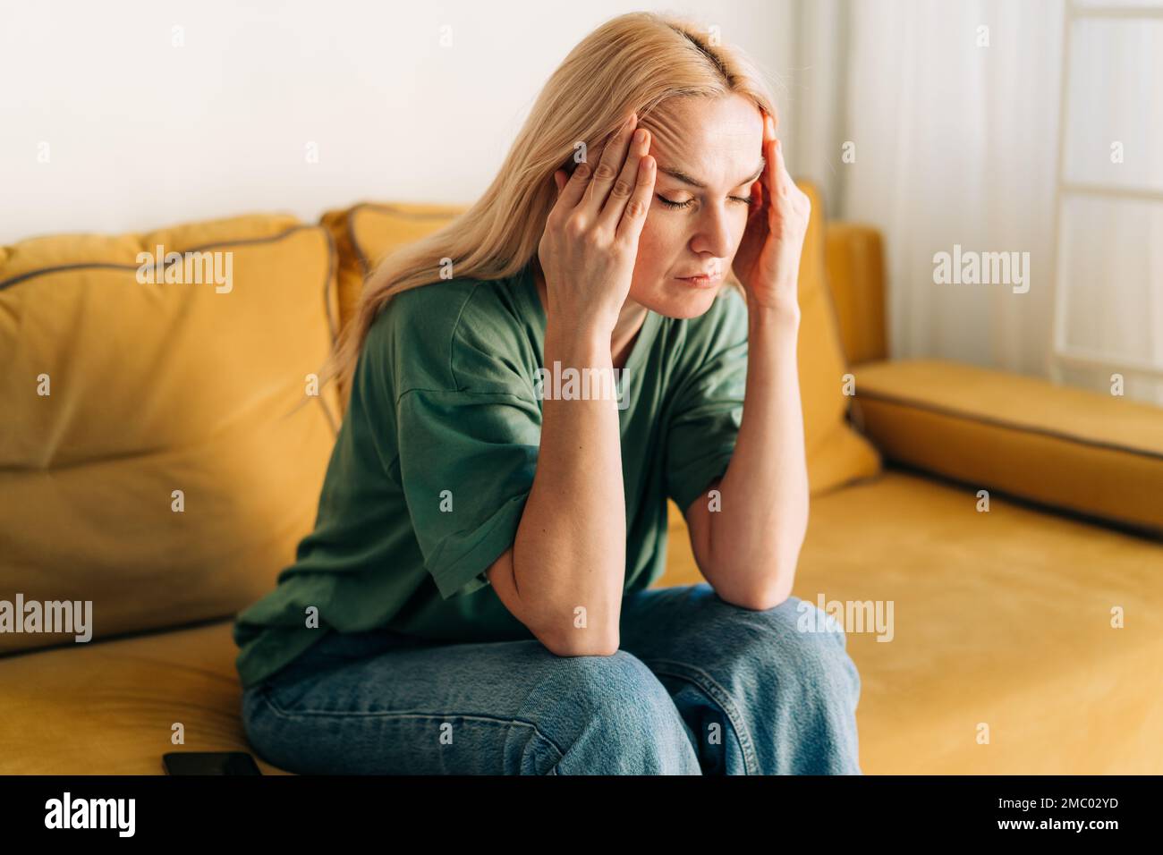 The woman suffers from a headache. Problems and stress affect a person ...