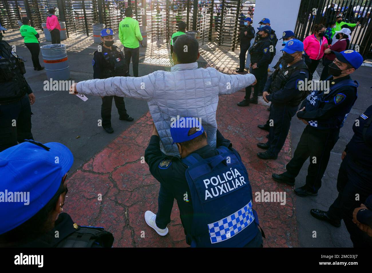 A fan is frisked before entering Azteca Stadium for a Mexican soccer ...