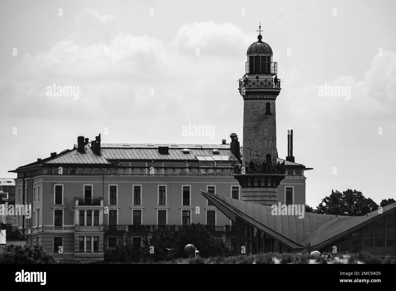 A dramatic grayscale view of the historic Warnemunde lighthouse in ...