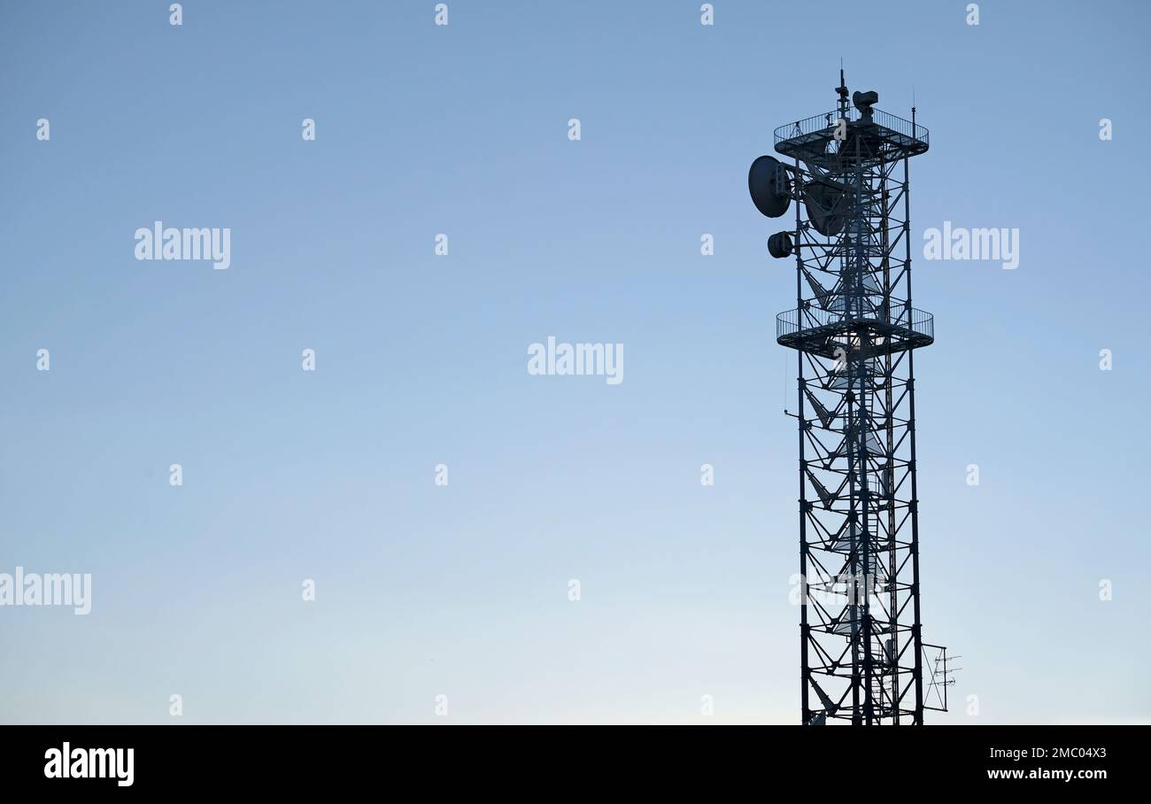 Telecommunication antenna against the blue sky Stock Photo - Alamy