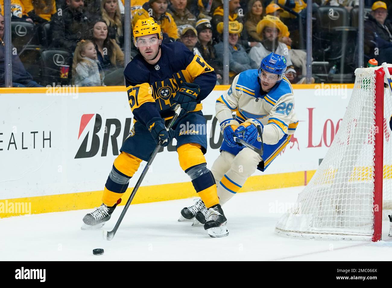 Nashville Predators' Dante Fabbro (57) moves the puck ahead of St ...