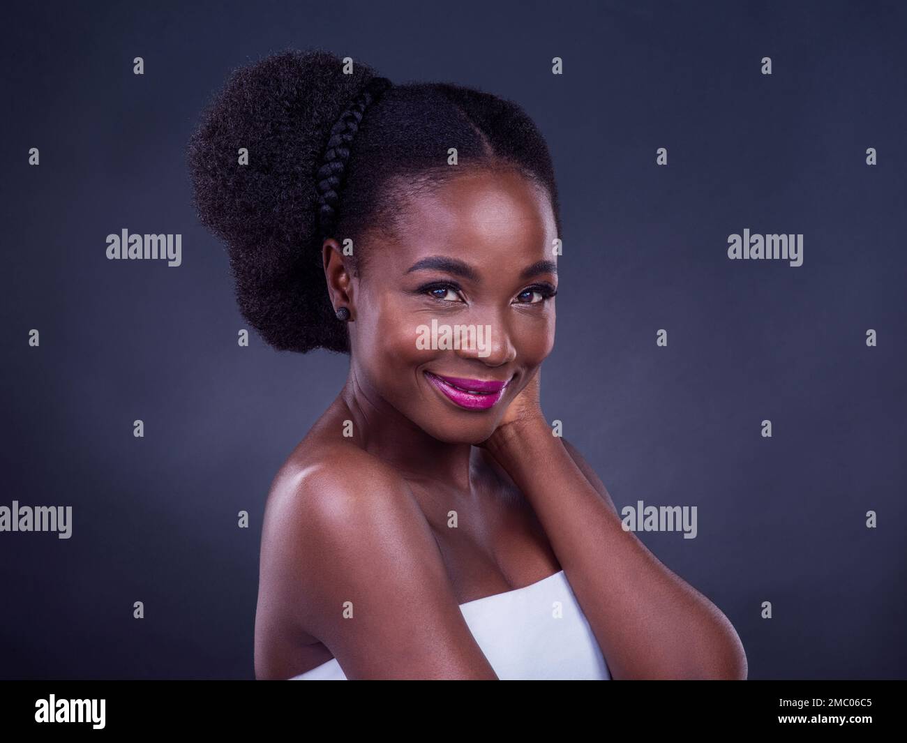 Skin first, makeup second, smile always. Studio portrait of a beautiful ...