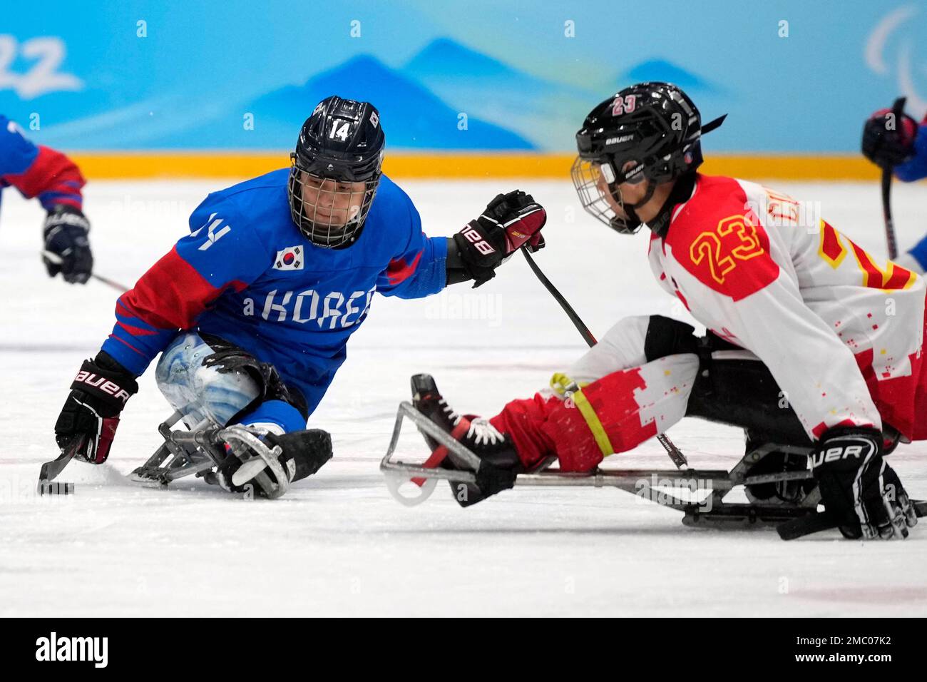 South Korea's Jung Seung-hwan and China's Cui Yutao battle for the puck ...