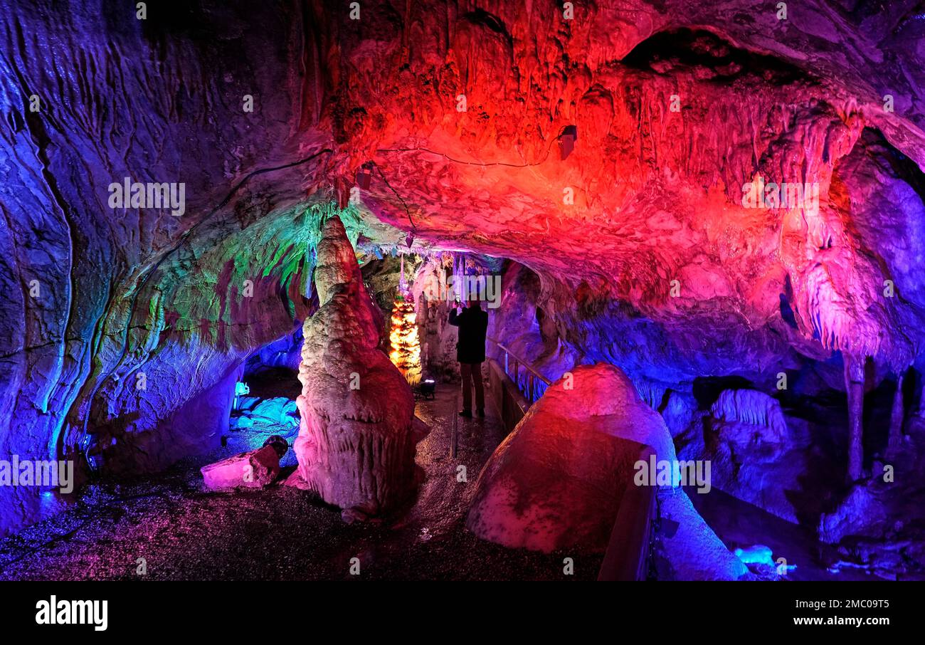 People visit the colorful, illuminated Dechen Cave in Iserlohn, Germany ...
