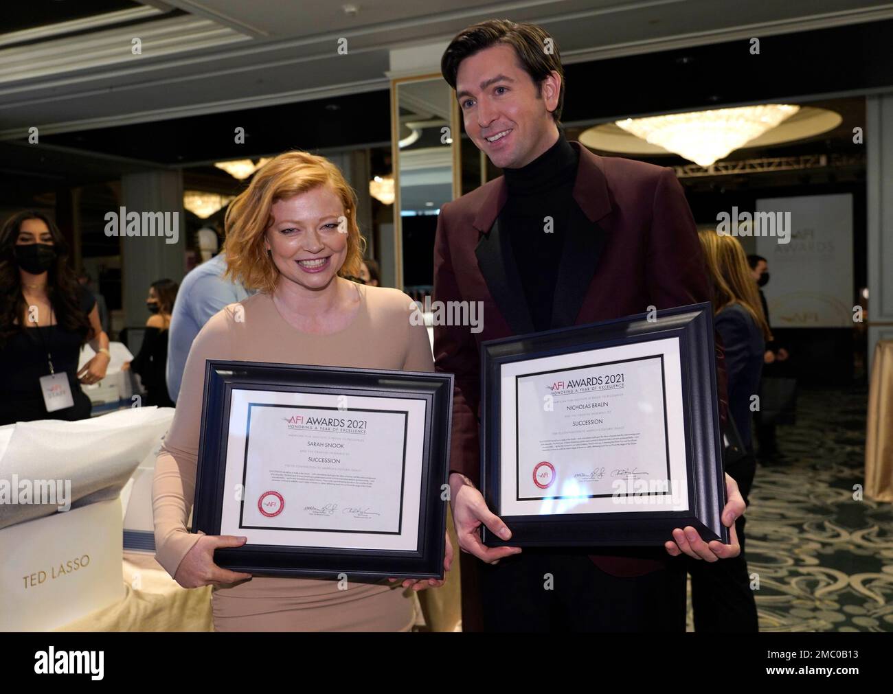 Sarah Snook, left, and Nicholas Braun pose with a certificate in honor ...
