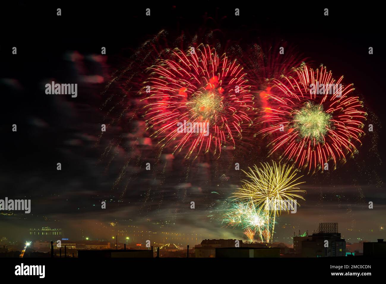 Red fireworks in a shape of daisy flower. Amazing firework explosions ...